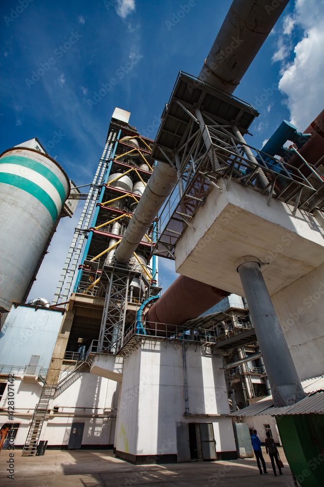 Standard Cement plant. Rotary clinker kiln, concrete silo tower and ...