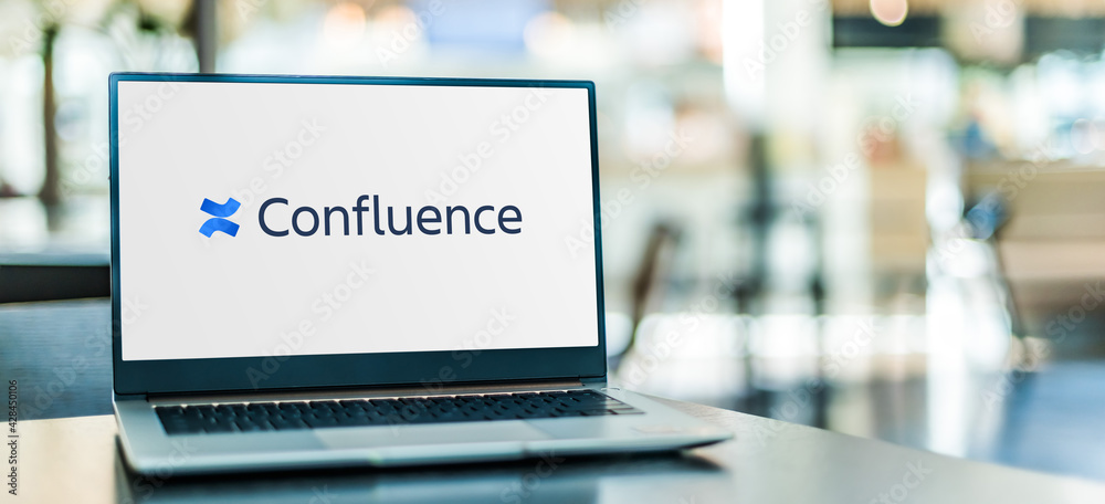 Laptop computer displaying logo of Confluence Stock Photo | Adobe Stock
