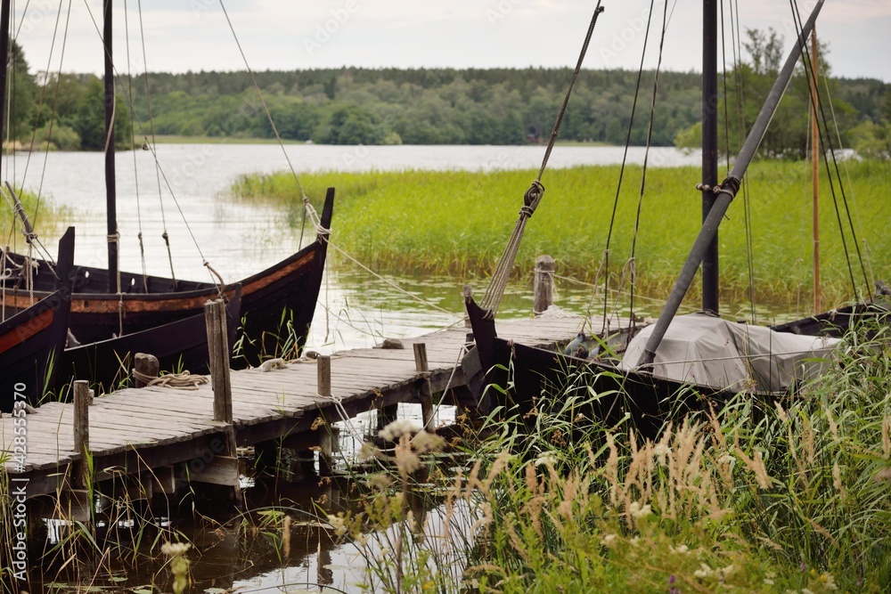 Wooden sailing boats moored to a pier. Birka, Björkö island, lake ...
