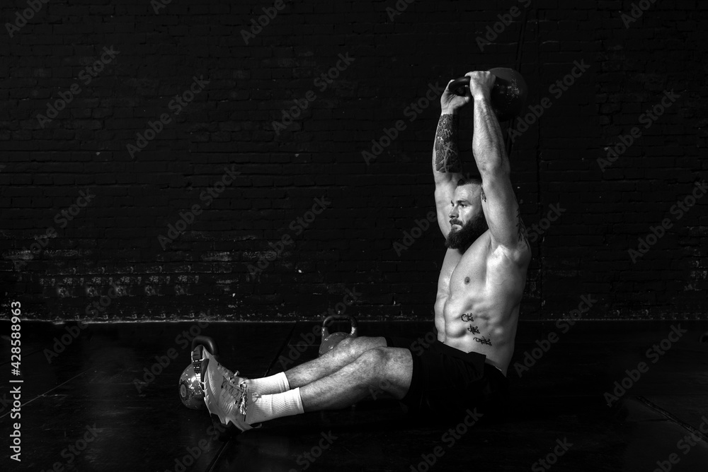 Young active sweaty strong muscular fit man with big muscles sitting on ...