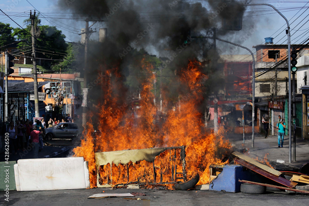 Residents set a barricade on fire to protest the constantly floods on ...