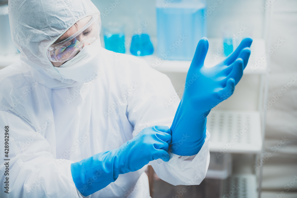 scientist or doctor wearing glove and mask for working in medicine ...