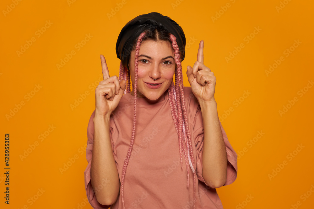 Cute girl with long box braids having excited look smiling pointing ...