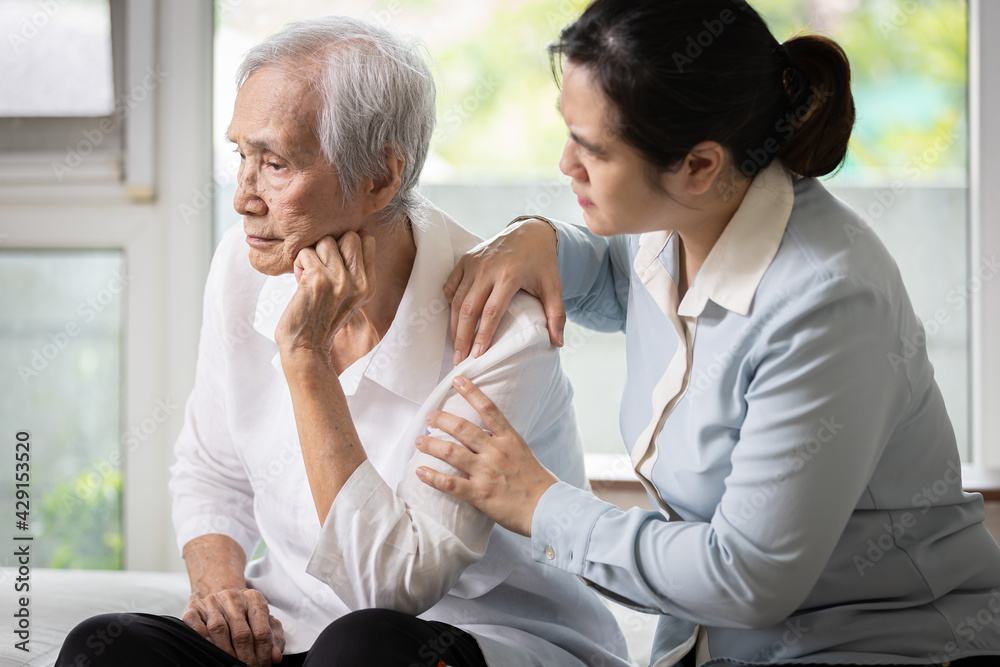 Sad elderly with depression,asian female caregiver or daughter ...