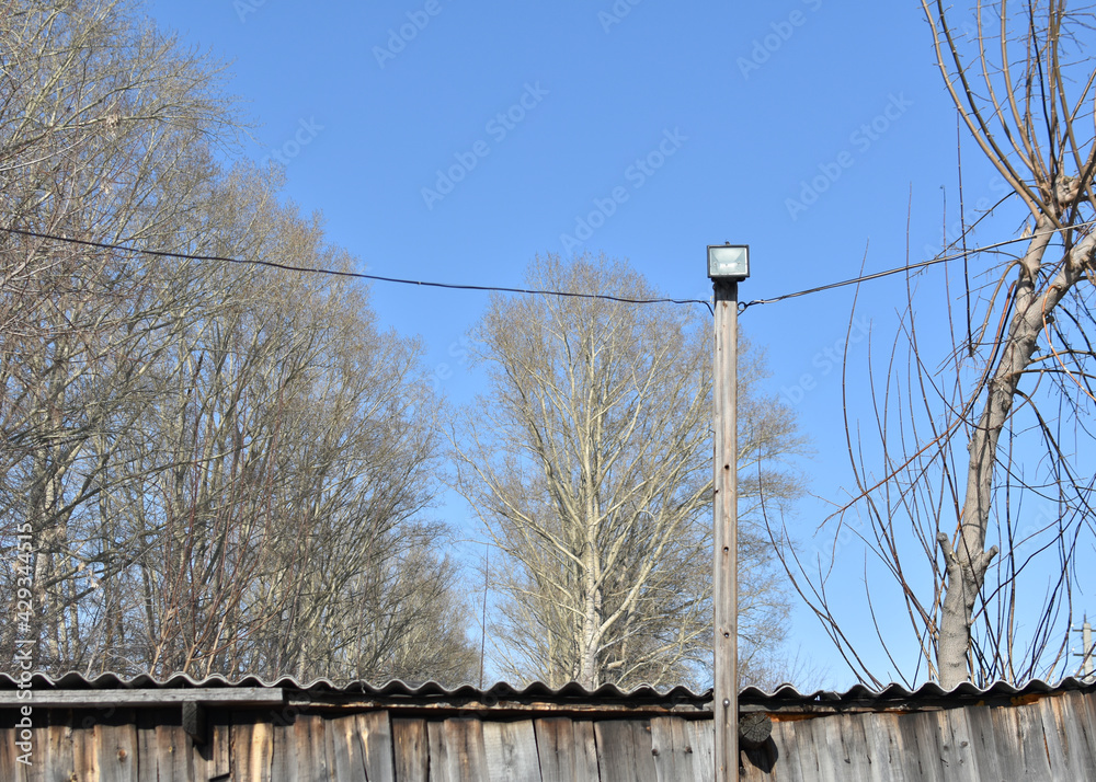 wooden support with diode soffit and wires. Rural landscape. homemade ...