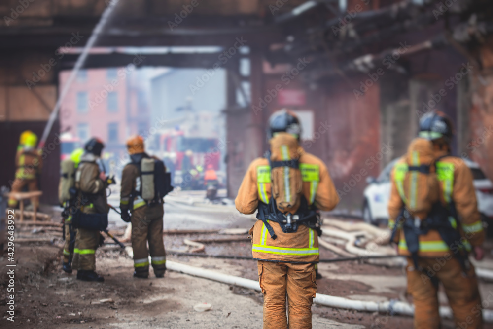 Firefighters put out large massive fire blaze, group of fire men in ...