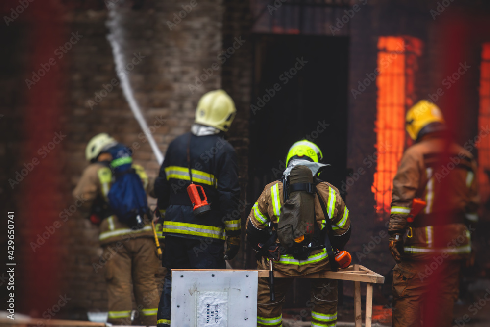 Firefighters put out large massive fire blaze, group of fire men in ...