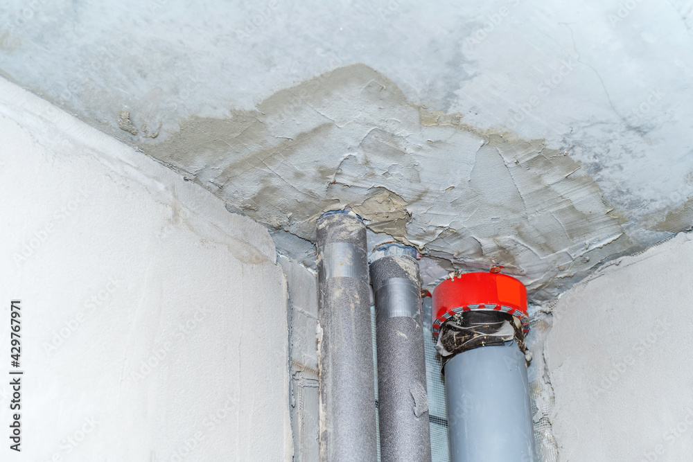 Sewer and water pipes installed in an apartment under construction ...
