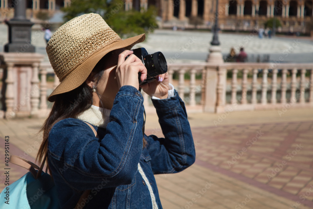 Young and beautiful asian tourist taking photos of monument with reflex ...