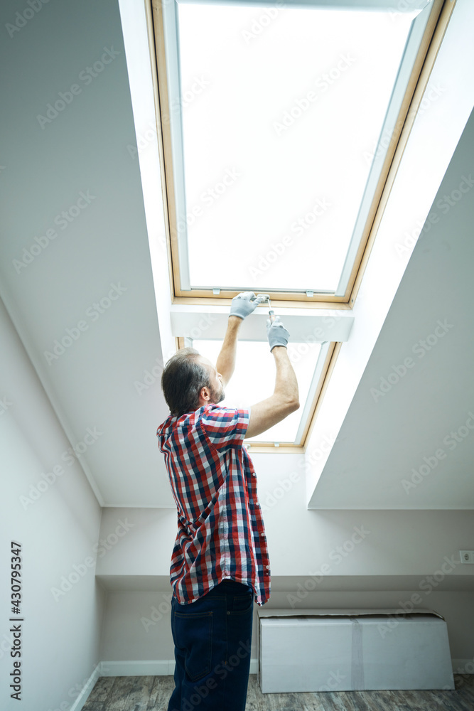 Make your house better. Handyman using screwdriver while fixing or ...