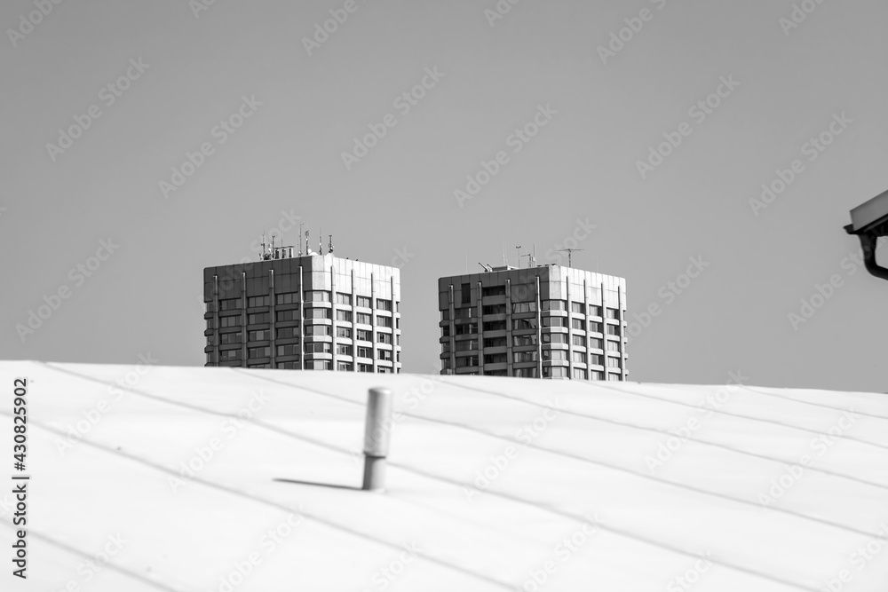 High up. Black and white image of Rooftop with a part of two high rise ...