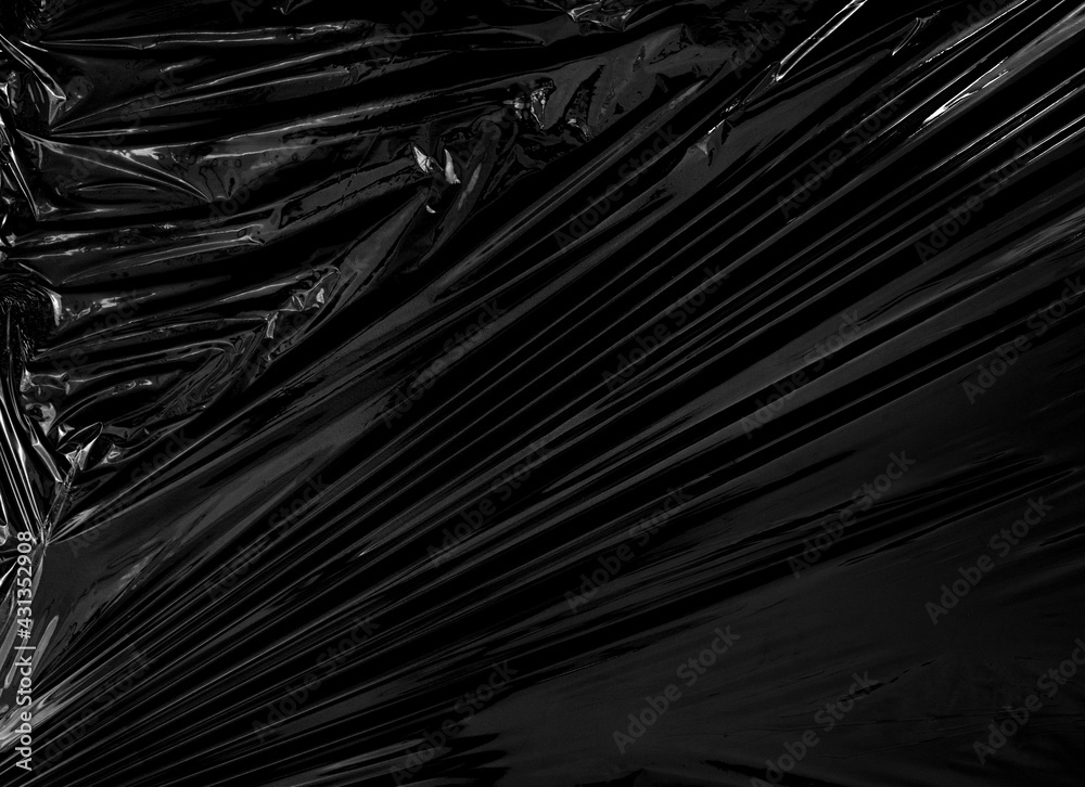 a transparent stretch plastic wrap on black background. realistic ...
