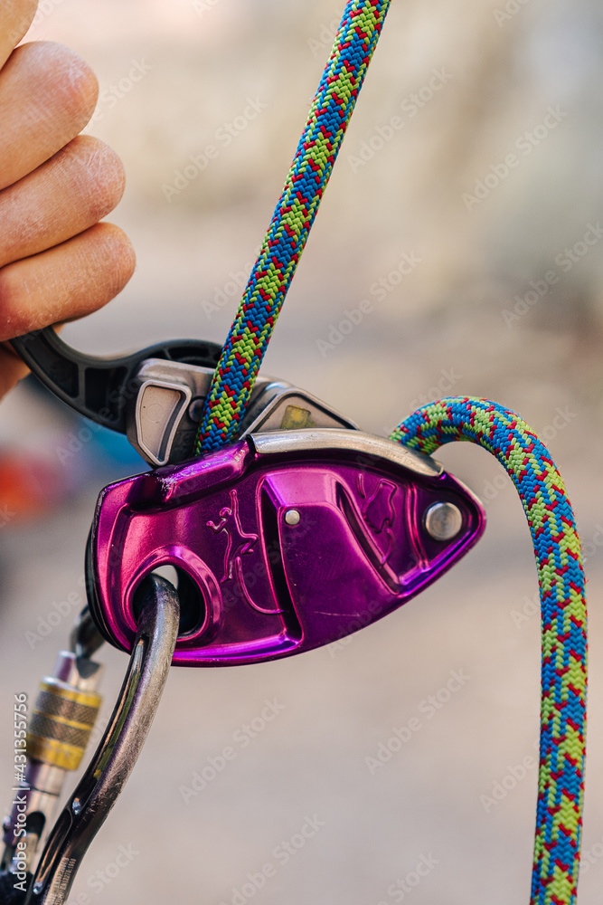 Close up photo of a belay device used by climbers. Climbing gear in ...