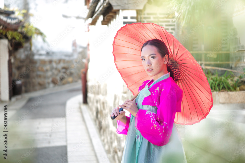 Стоковое фото «Korean girl wearing a hanbok wearing Pink umbrella. The ...