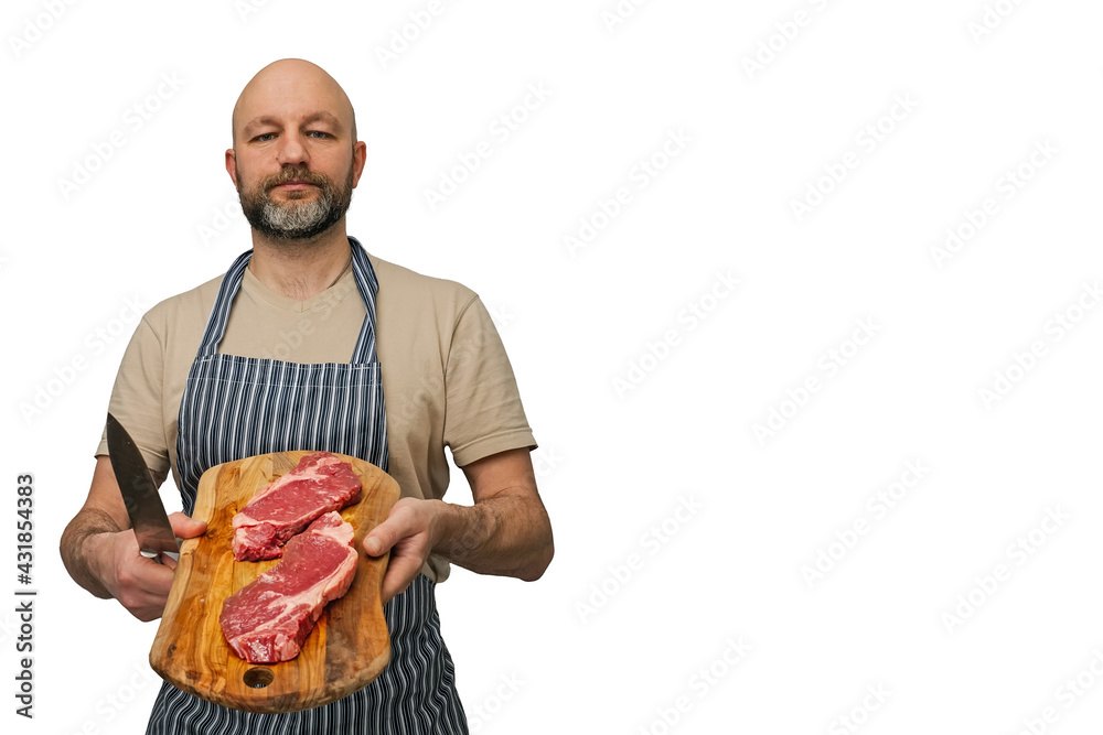 Bald butcher holding wooden cutting board with two fresh strip loin ...
