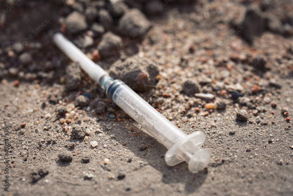 Dropped used syringe with needle on the ground, drug addict. Threat of ...