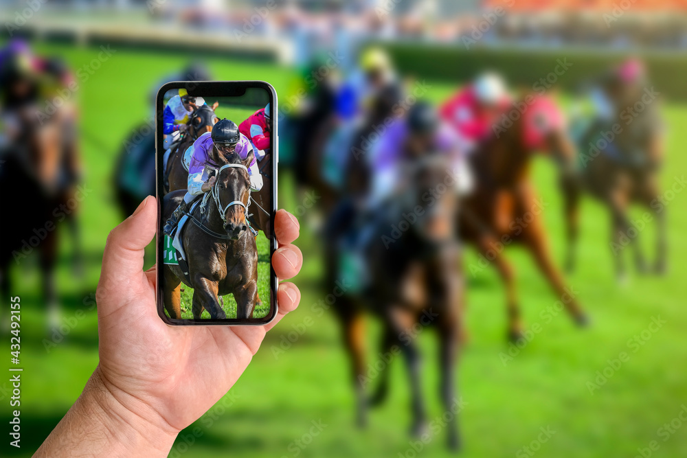 Man taking photo of horse racing Stock Photo | Adobe Stock