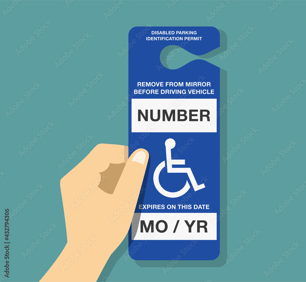 Hand holding a handicap placard. Disabled parking permit identification ...