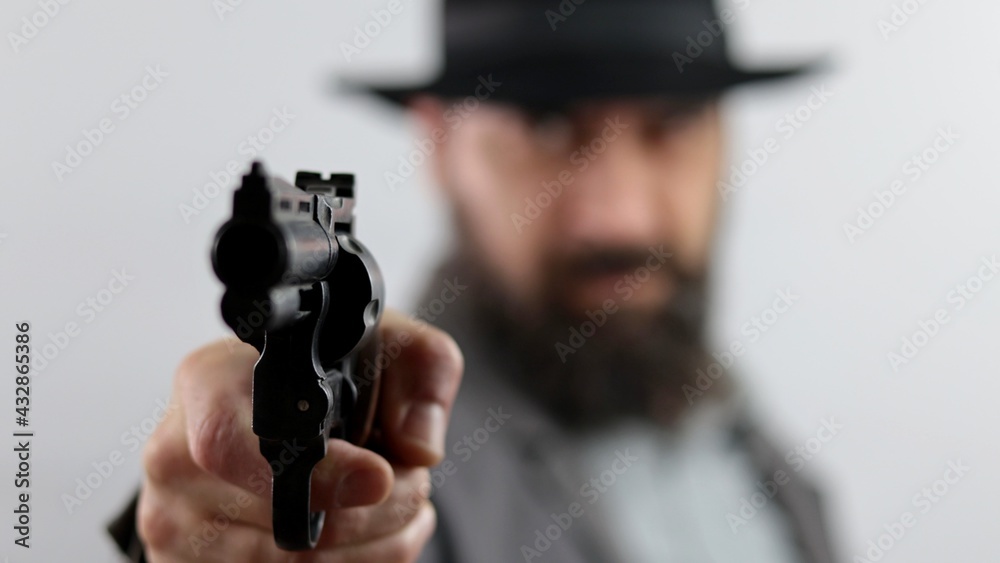 Bandit, gangster or detective pointing gun at the camera, isolated on ...
