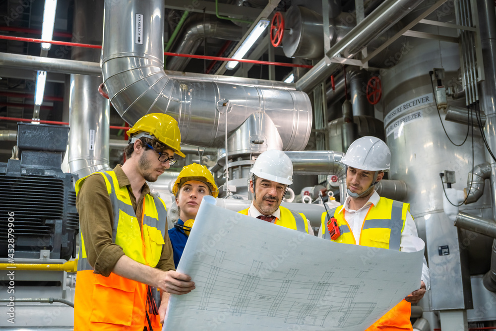 Engineer and Foreman are discussing the plant layout on the blueprint ...