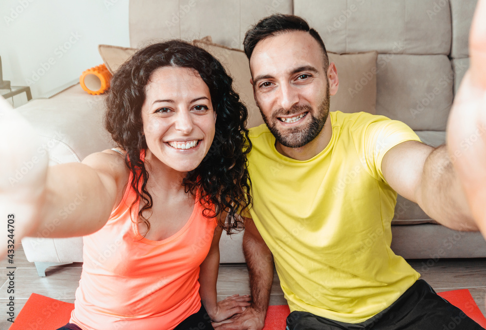 Engaged couple practice sports at home and take a selfie with their ...