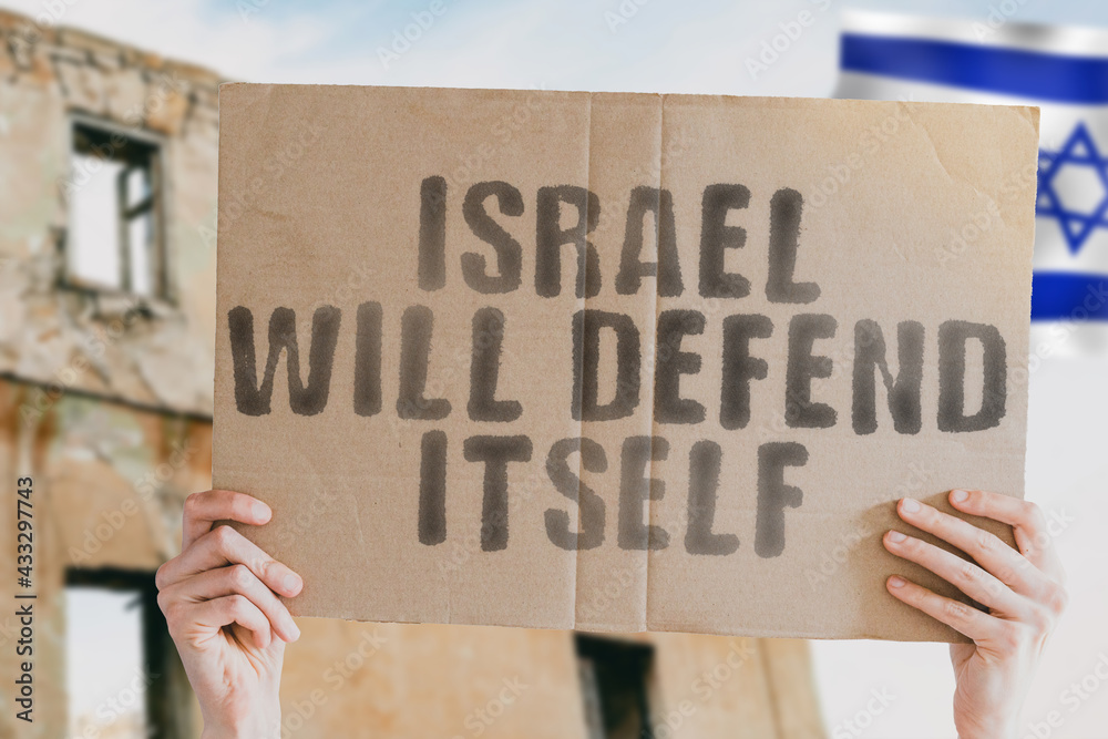 The phrase " Israel will defend itself " on a banner in men's hand with ...