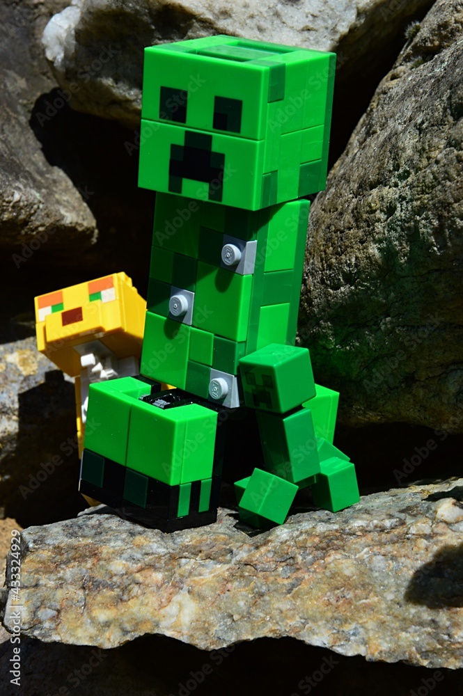 LEGO large figure of Creeper monster mob standing on rock, Ocelot cat ...