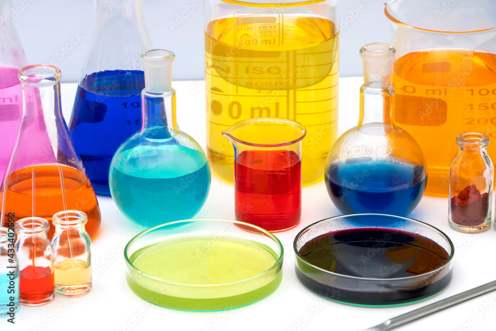 Laboratory glassware with various colored liquids in chemistry ...
