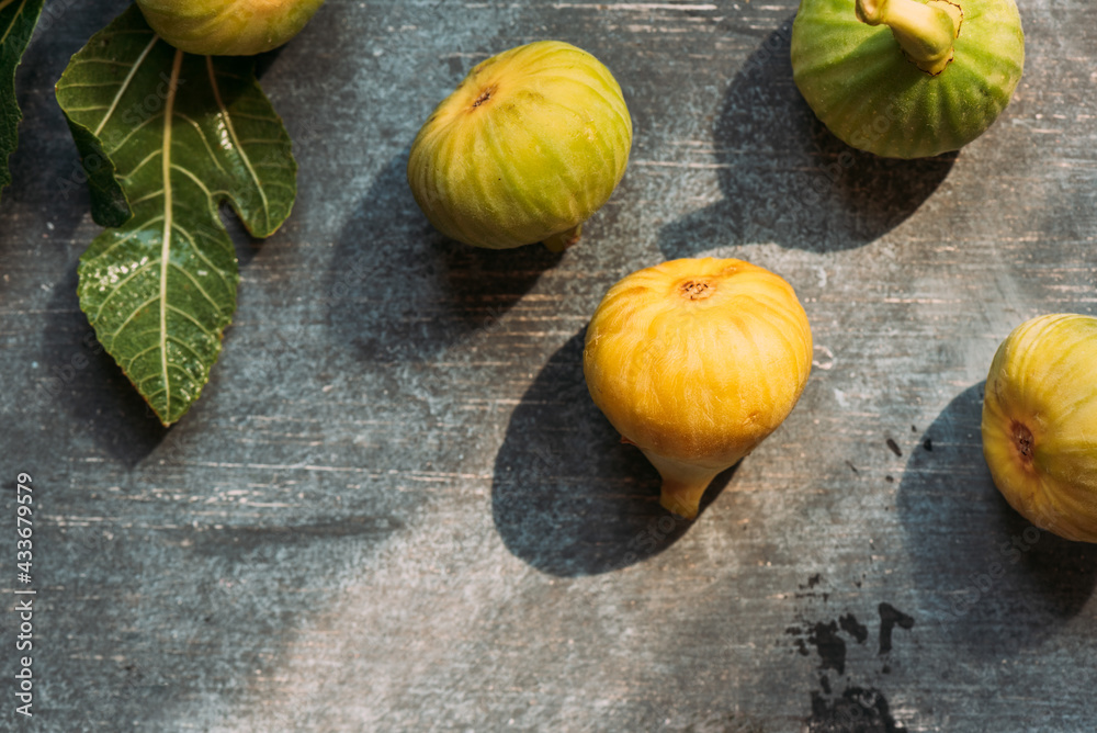 Ripe sweet green figs, freshly harvested from domestic tree, on table ...