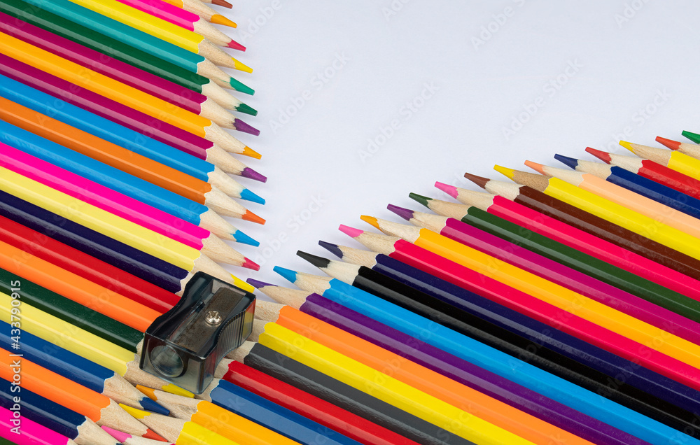 Background photo of colored pencils and a sharpener forming an ...