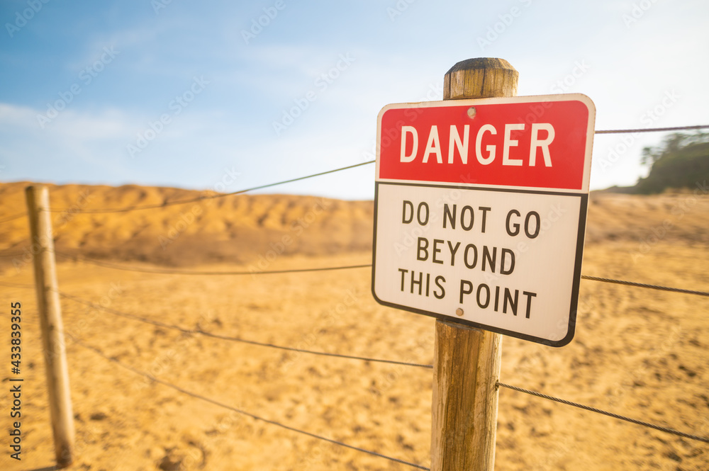 Foto Hazard warning sign. You cannot go beyond this border. Desert ...