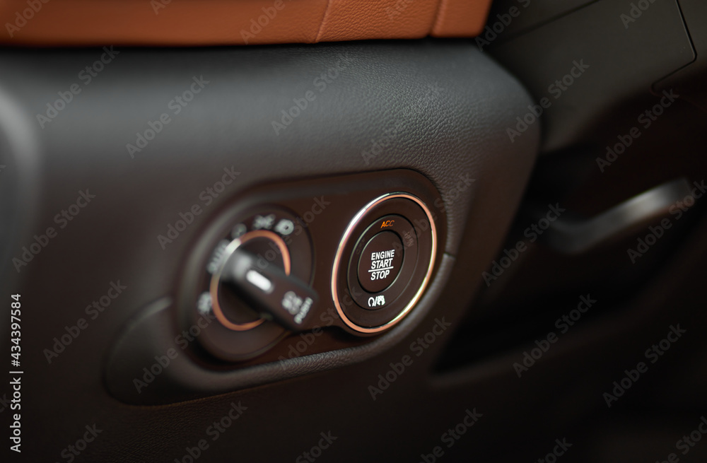 A Start-stop button to start the engine in a luxury car. A button ...
