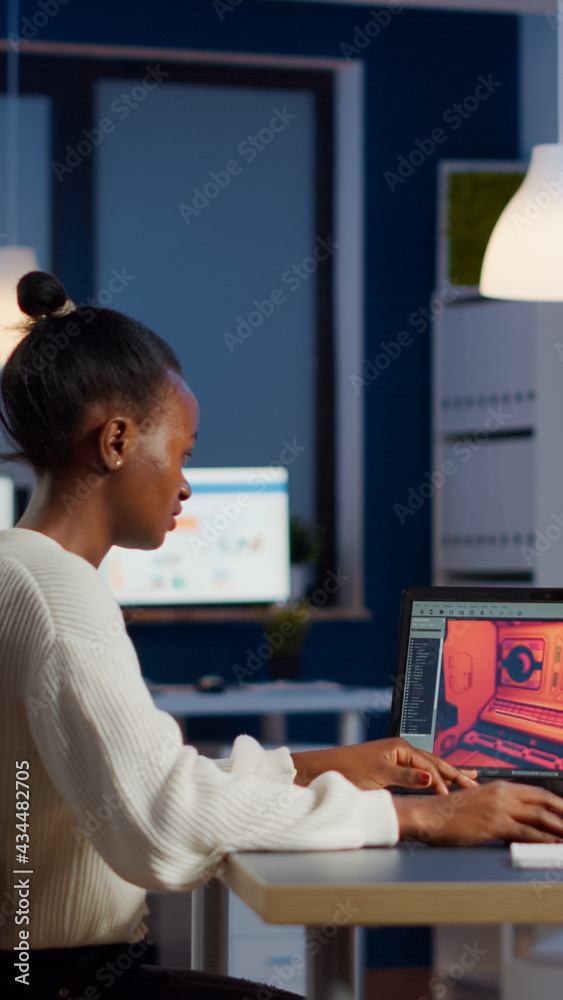 Dark skin gamer developer working at video game in midnight from ...
