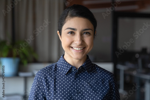Close up headshot portrait of smiling young Indian female employee look ...