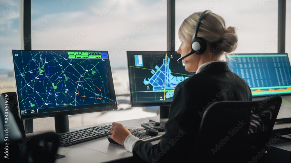 Female Air Traffic Controller with Headset Talk on a Call in Airport ...