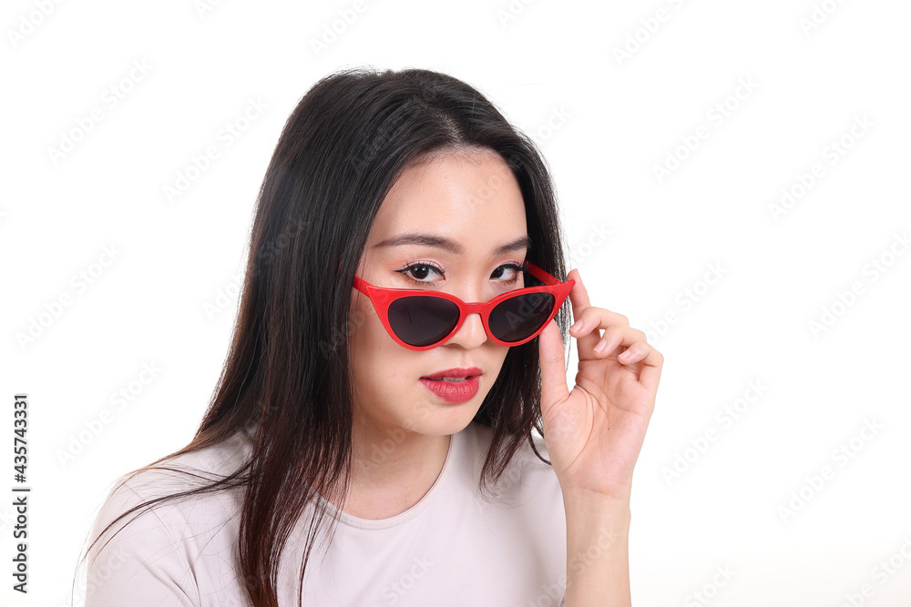 Beautiful young south east Asian woman peaking over wearing red frame ...