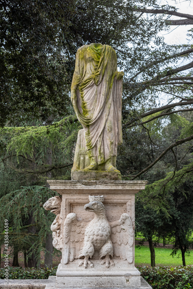 Headless ancient roman sculpture decorating Villa Borghese garden in ...