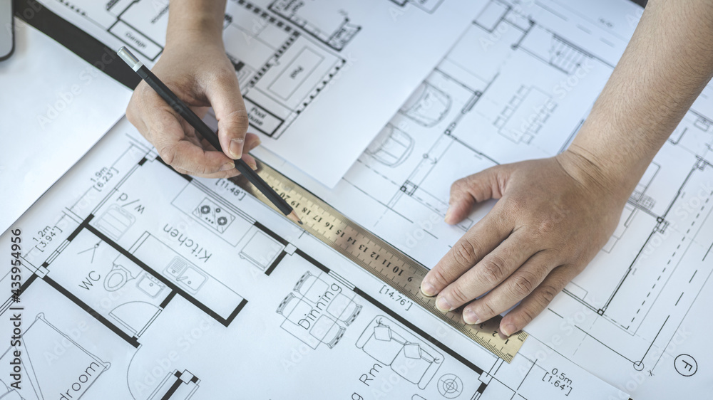Engineer and Architect concept, Man uses a ruler to measure the floor ...