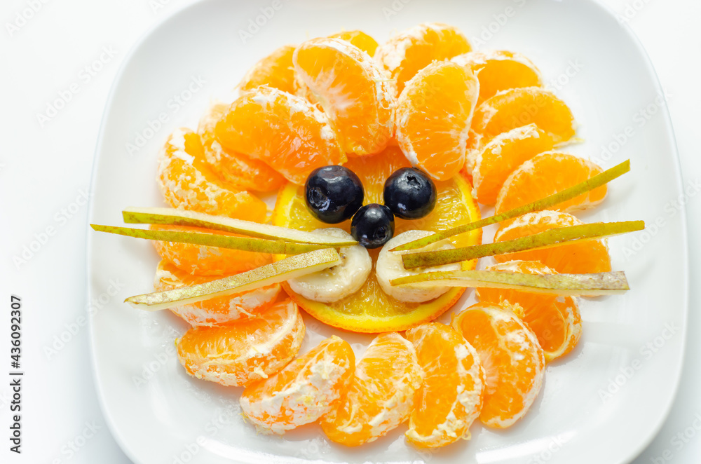 Fresh fruit orange, mandarin, banana, grape and pear served in a ...