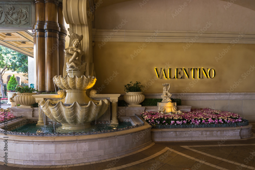 Beautiful fountain and famous boutique Valentino sign at the main ...