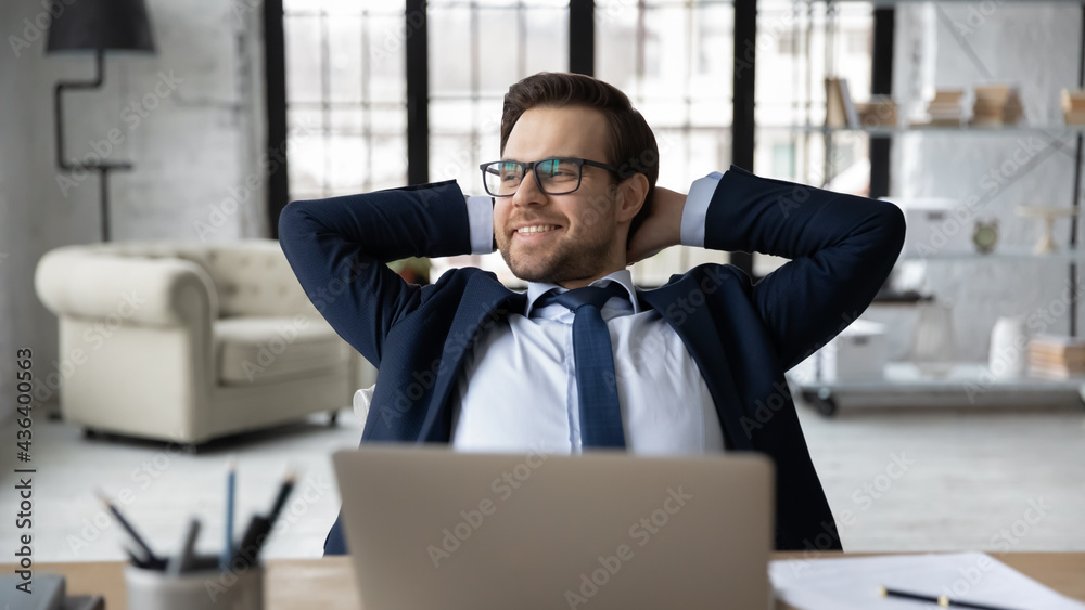 Happy manager relaxing at workplace in office, enjoying work break and ...