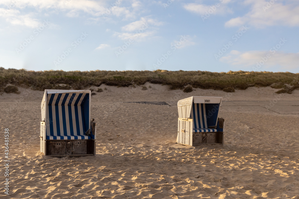 Sylt island beach landscape with two empty beach chair and fine sand on ...