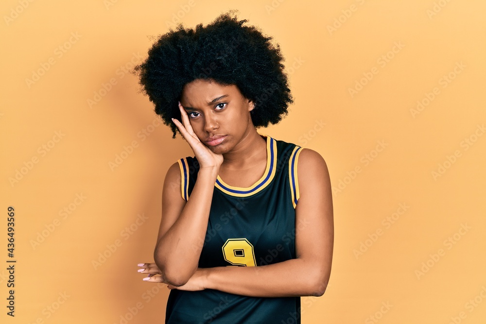 Young african american woman wearing basketball uniform thinking ...