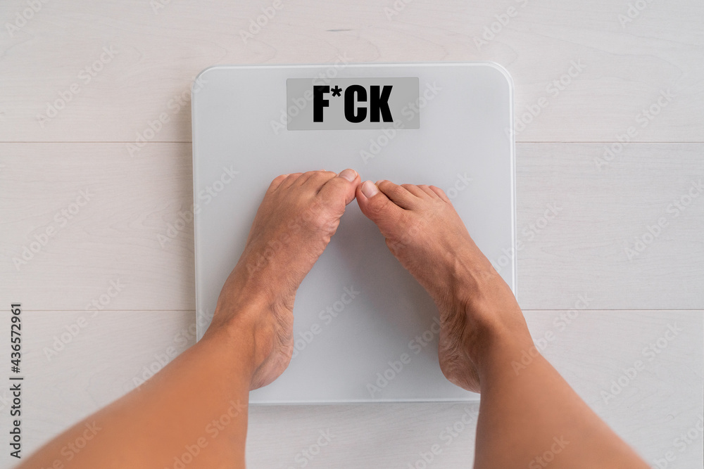 Funny weight gain woman weighting herself on weight balance scale ...