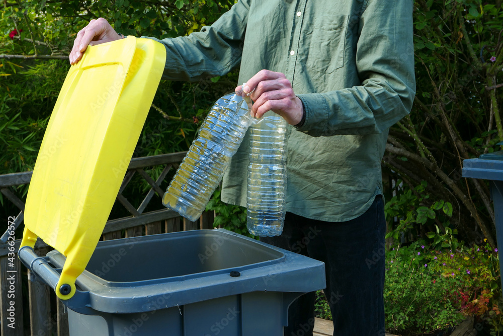 One person making a selective sorting of waste. Man putting plastic ...