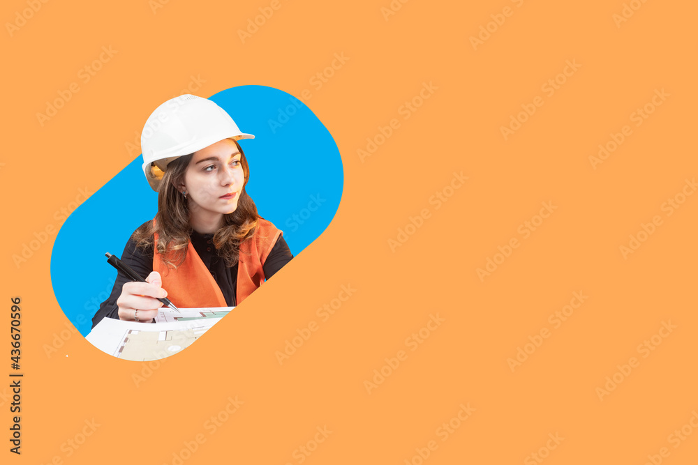 Young woman architect. Girl builder on an orange background. Young ...