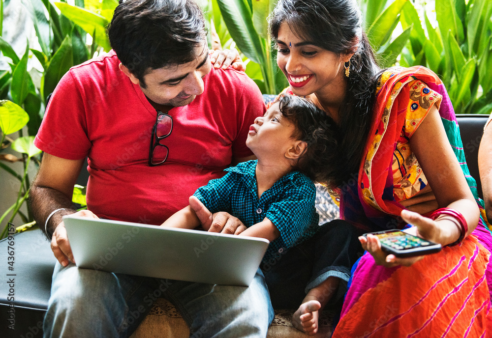 Happy Indian family using a laptop Stock Photo | Adobe Stock