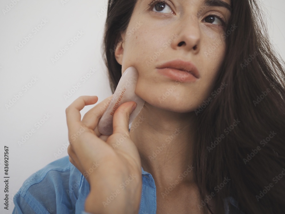 young beautiful woman makes a dry brush massage, esthetics and body ...