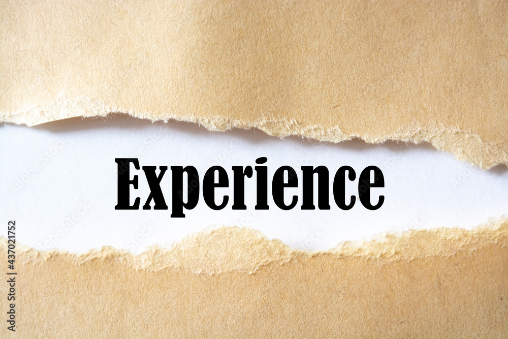 The text, experience, appears behind torn brown paper Stock Photo ...