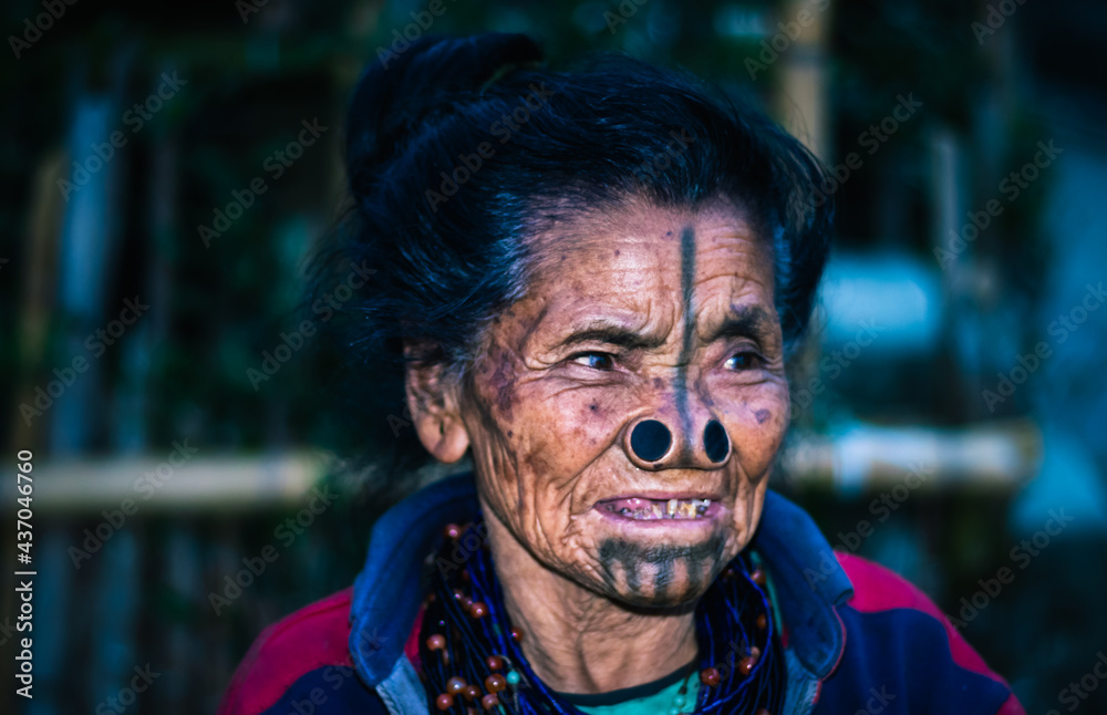 apatani tribal women facial expression with her traditional nose lobes ...
